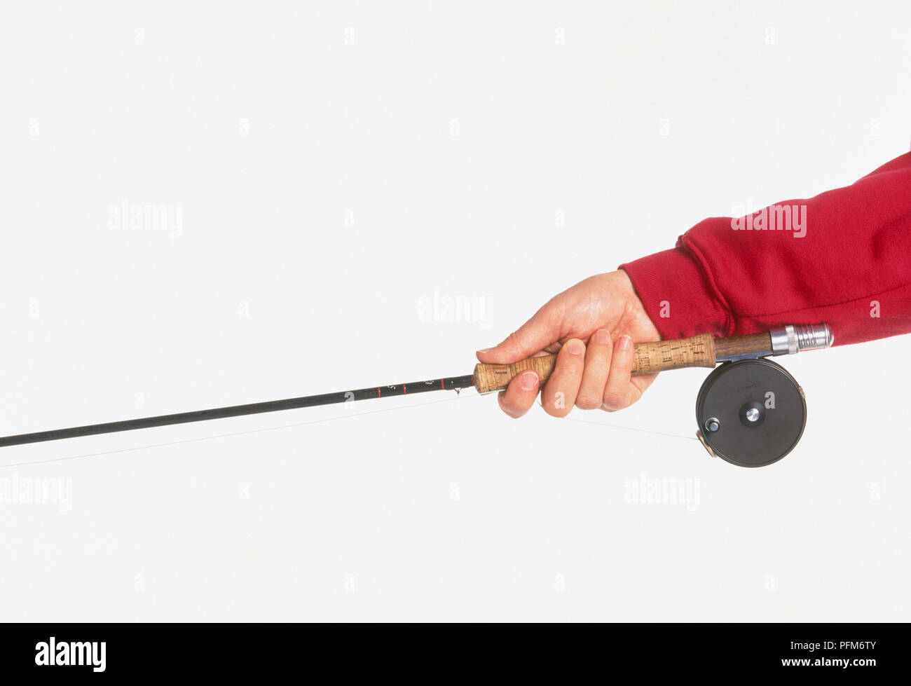 Hand holding fishing rod, close-up Stock Photo - Alamy