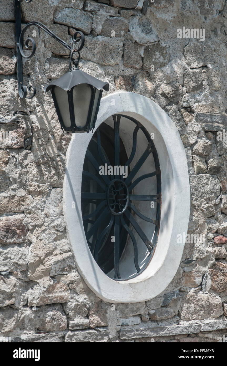 Round window on the facade of old stone house closeup Stock Photo - Alamy