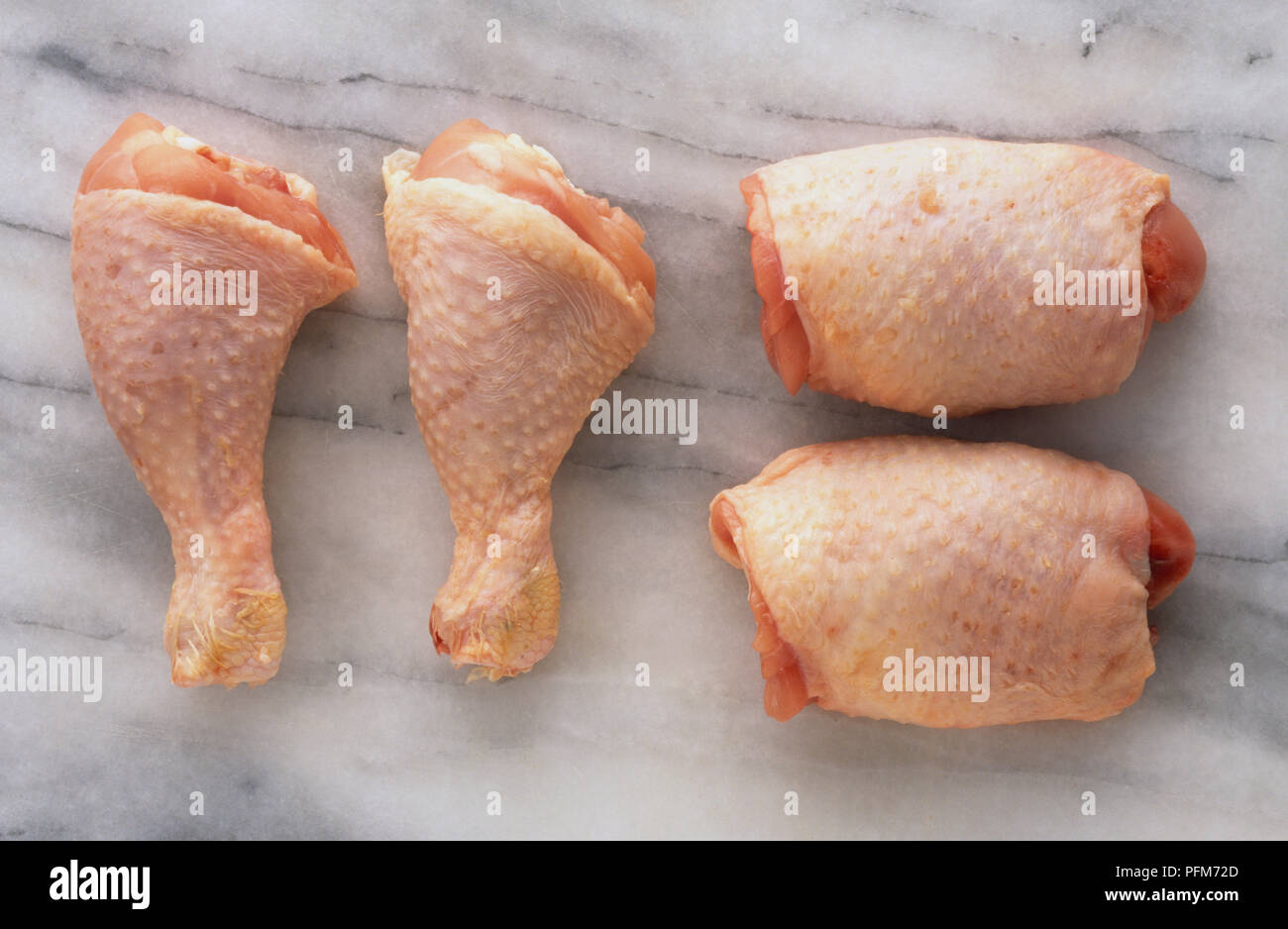 Chopped chicken legs on granite work surface, overhead view Stock Photo ...