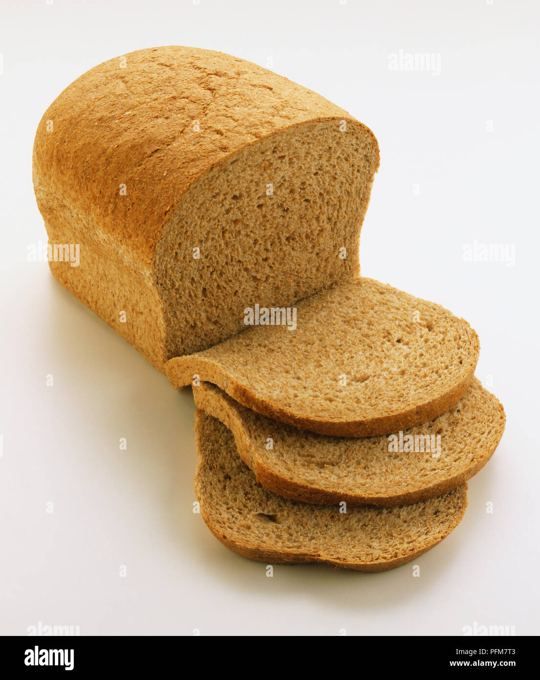 Whole loaf of brown bread cut with three slices Stock Photo - Alamy