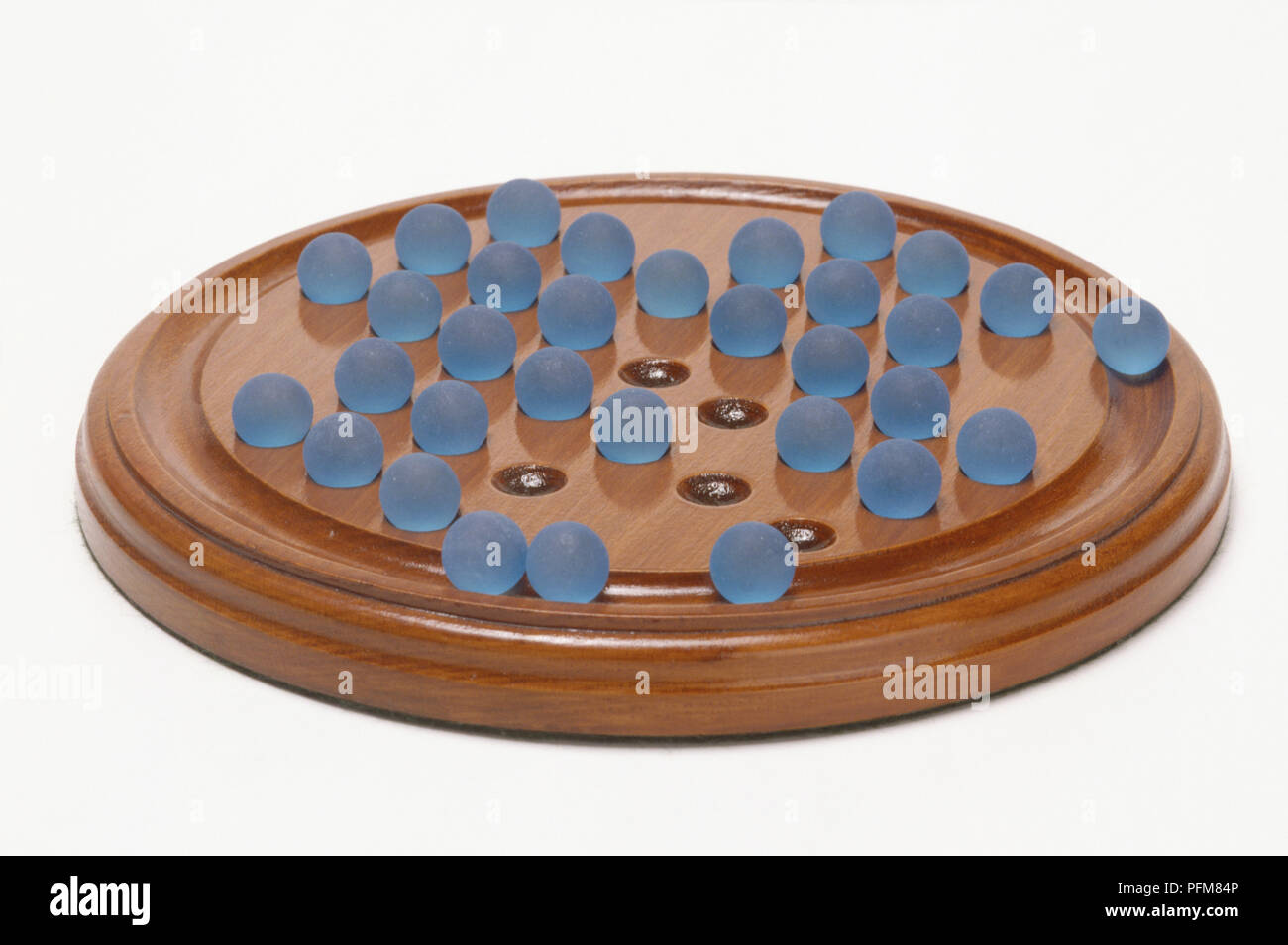 Solitaire board with blue marbles Stock Photo - Alamy