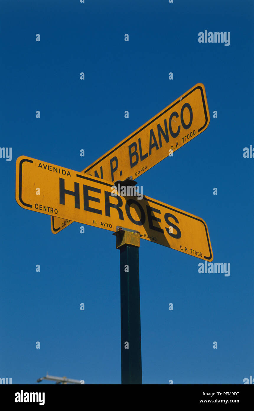 Mexico, Yucatan, crossed yellow street signs on a pole, low angle view ...