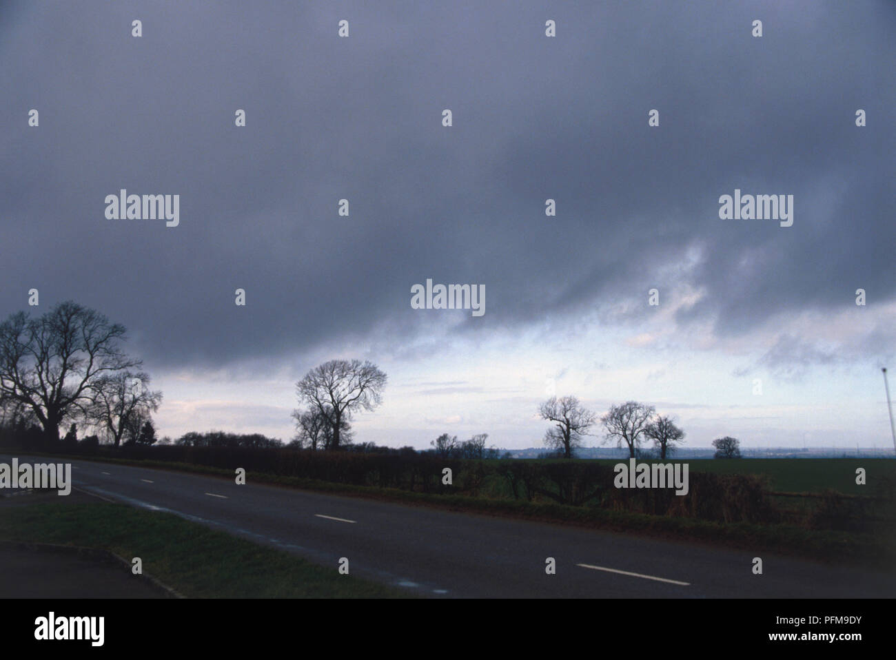 Stratocumulus, heavy grey clouds with light, patchy rain, darkening sky ...