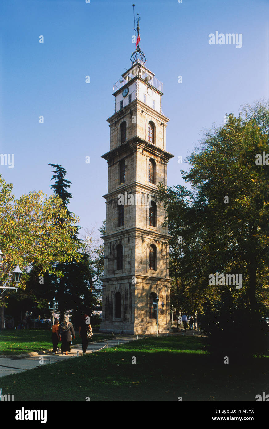 Asia, Turkey, Trophane, tall clocktower reaching into blue sky, trees ...