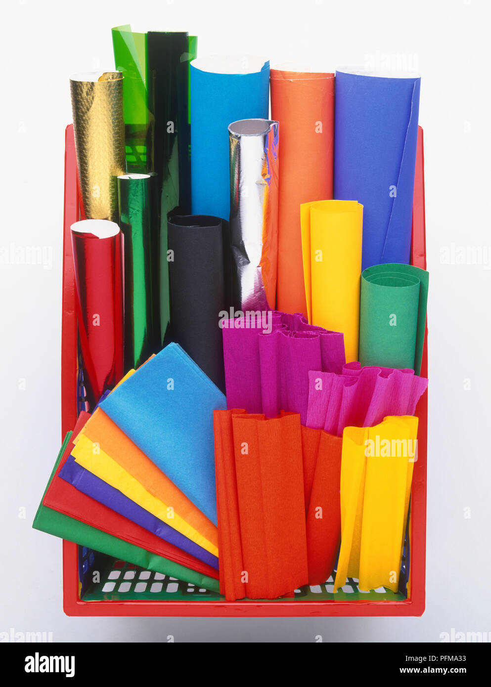 Selection of coloured paper rolls in plastic crate, view from above ...