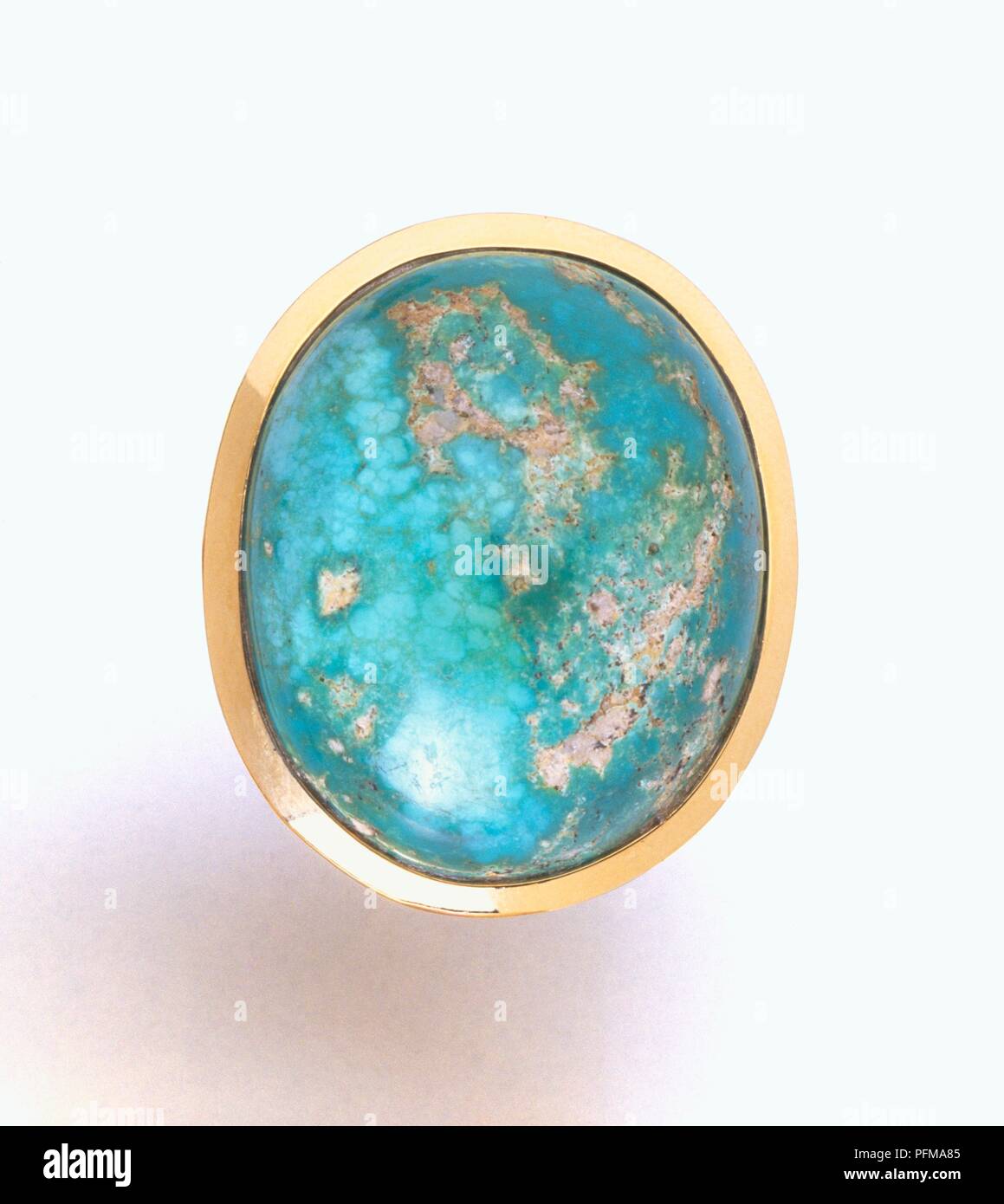 Turquoise stone set in gold ring Stock Photo - Alamy