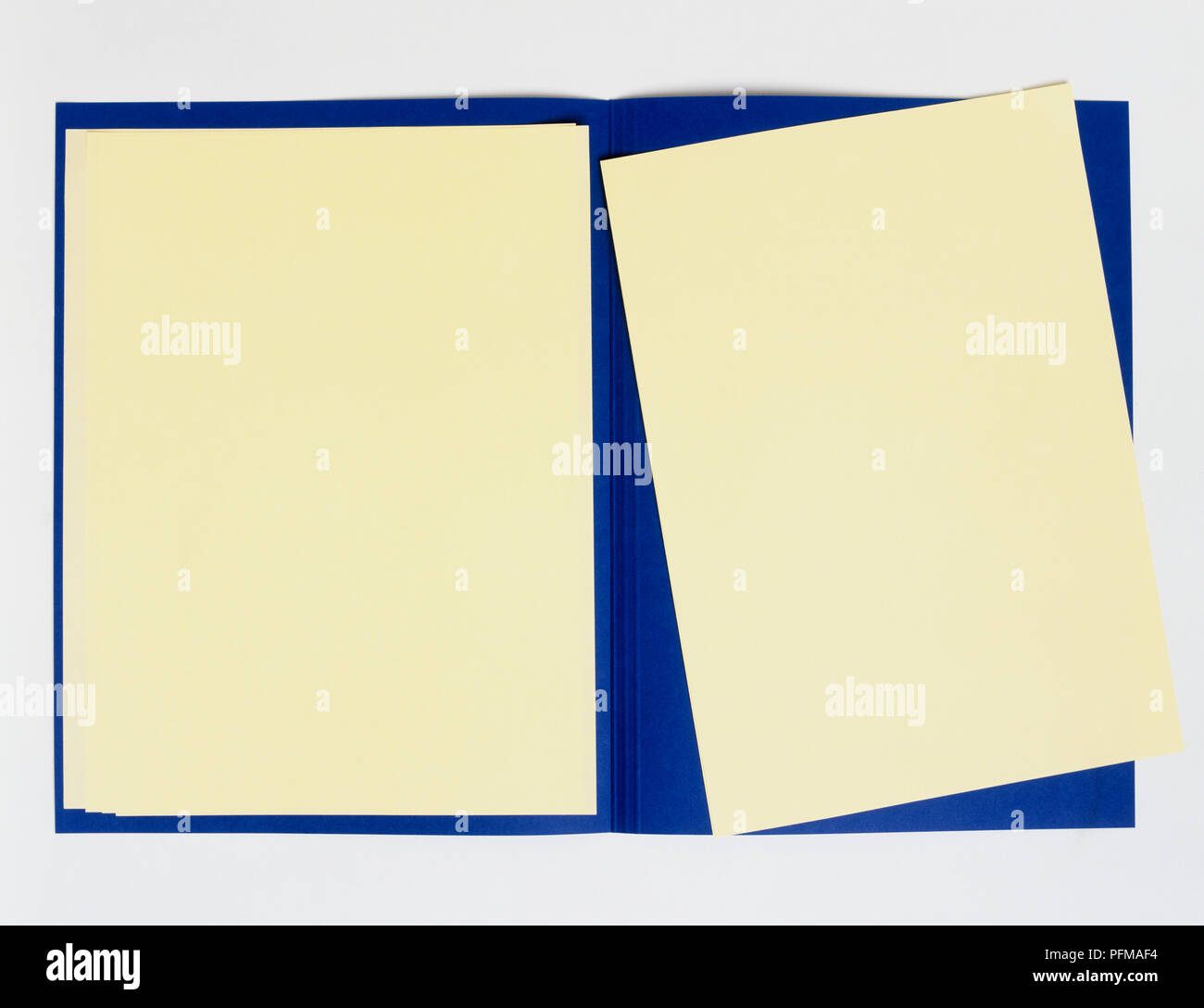 Sheets of yellow paper in an open blue file Stock Photo - Alamy