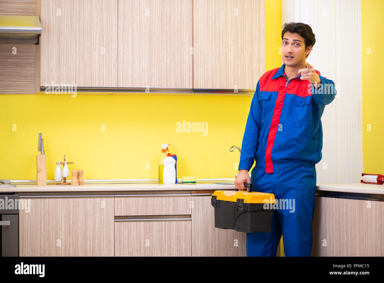 Plumber repairing tap at kitchen Stock Photo - Alamy