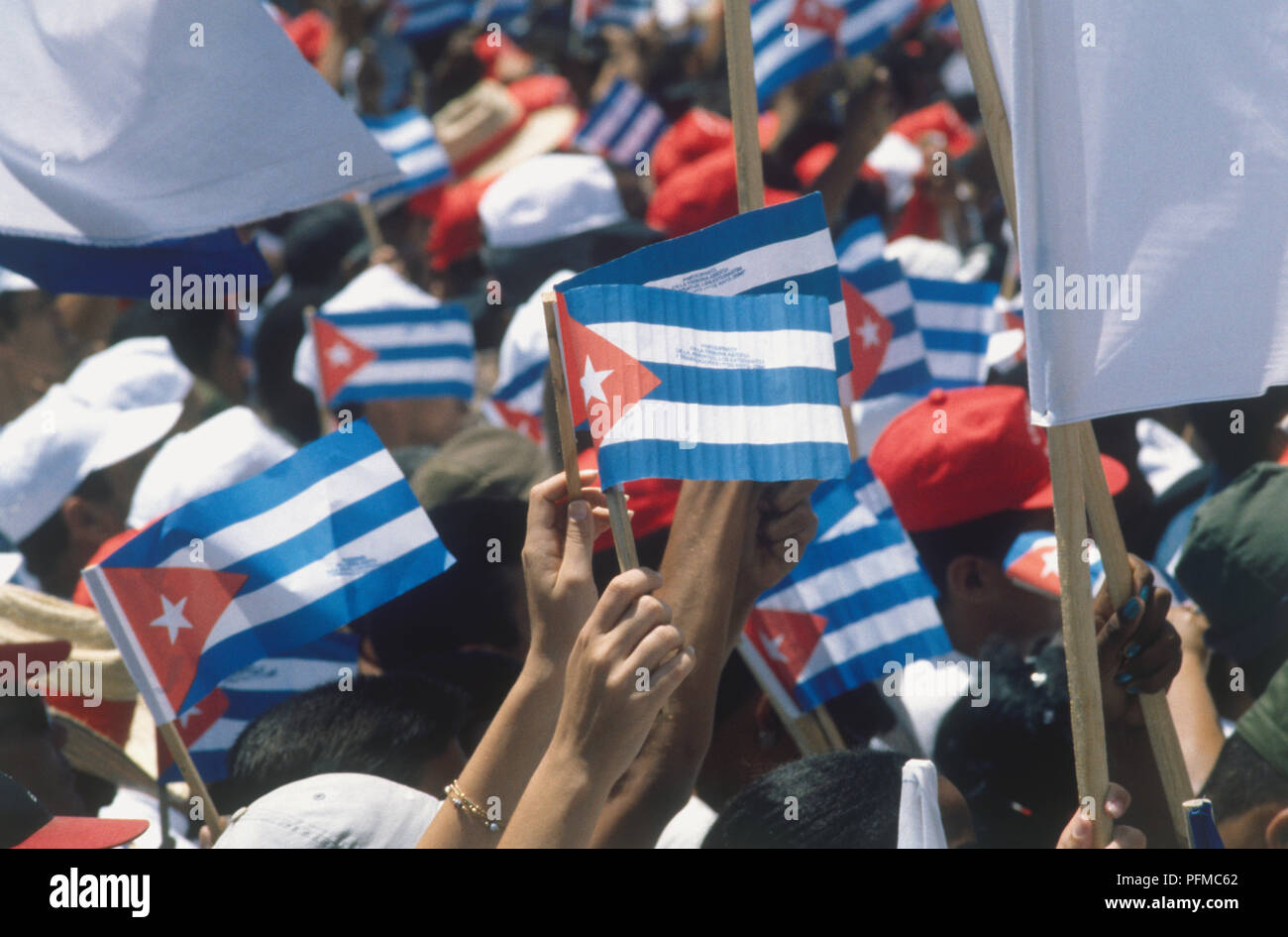 Cuba, crowd waving flags at rally Stock Photo - Alamy