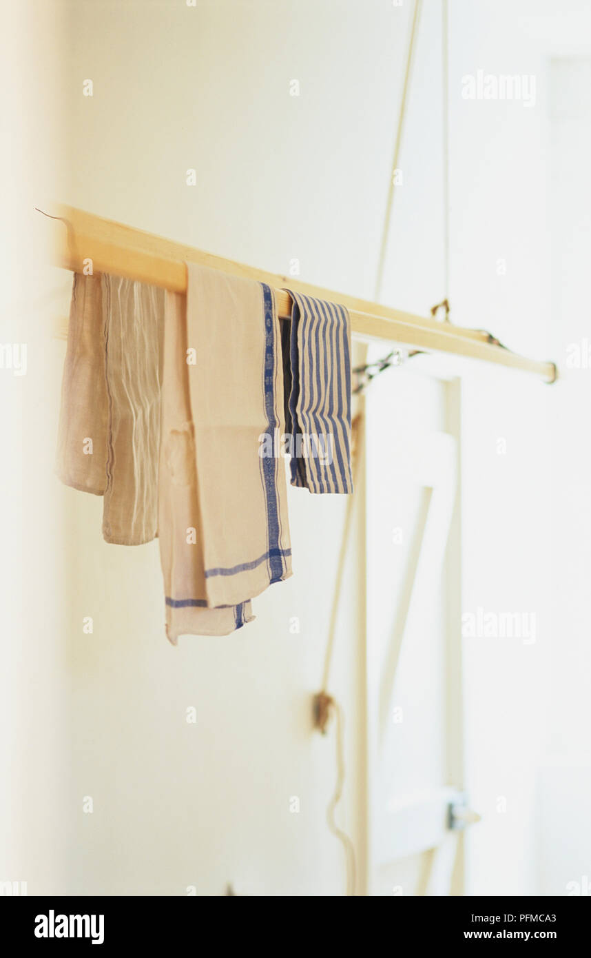 Tea towels drying on a hanging wooden rail, low angle view Stock Photo ...