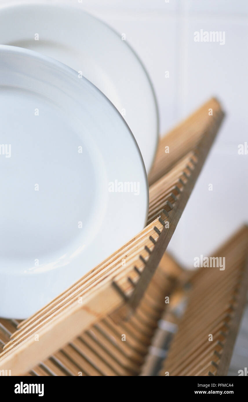 Close-up of plates drying on a wooden plate rack Stock Photo - Alamy