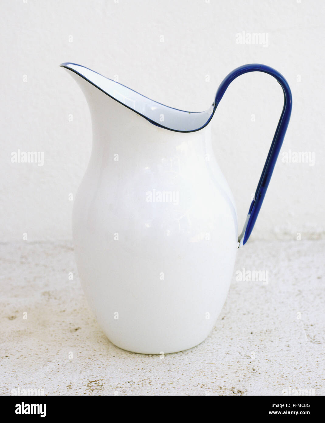 White jug with blue edging, side view Stock Photo - Alamy