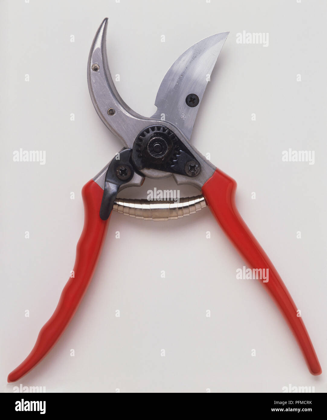 Open pair of secateurs with red handles, close up Stock Photo - Alamy