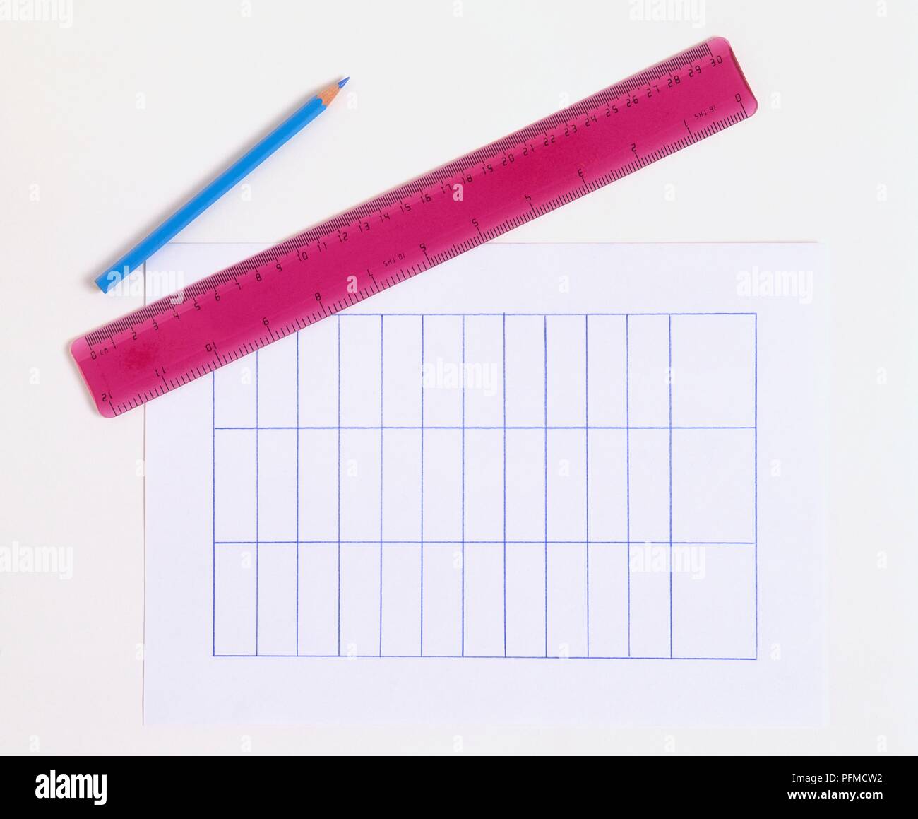 Pink plastic ruler and blue pencil on grid drawn on white paper Stock ...