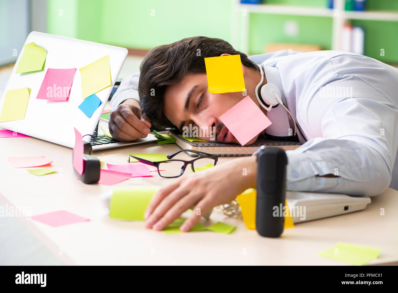 Young help desk operator working in office with many conflicting ...