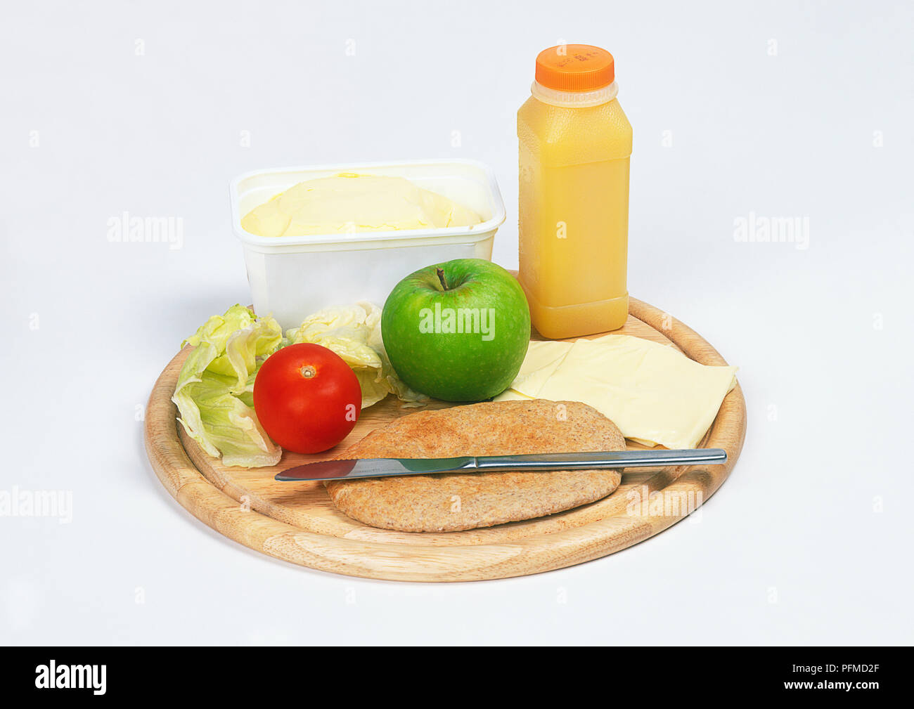 Bottle of fresh orange juice, tub of margarine, apple, tomato, lettuce ...