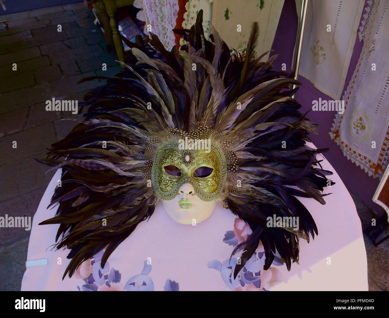 A traditional Venetian ball mask for a woman displayed in a souvenir ...