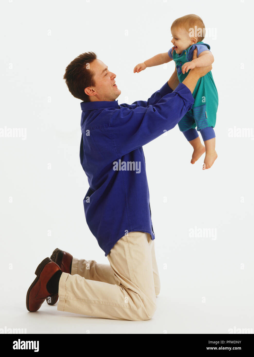 Young father lifting up his baby daughter Stock Photo - Alamy