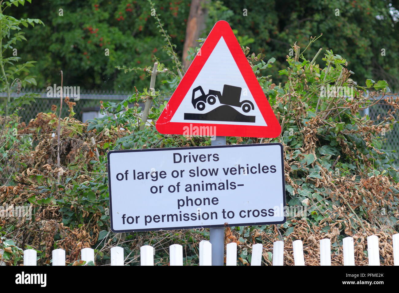 A sign at a level crossing advising drivers of slow and abnormal load ...