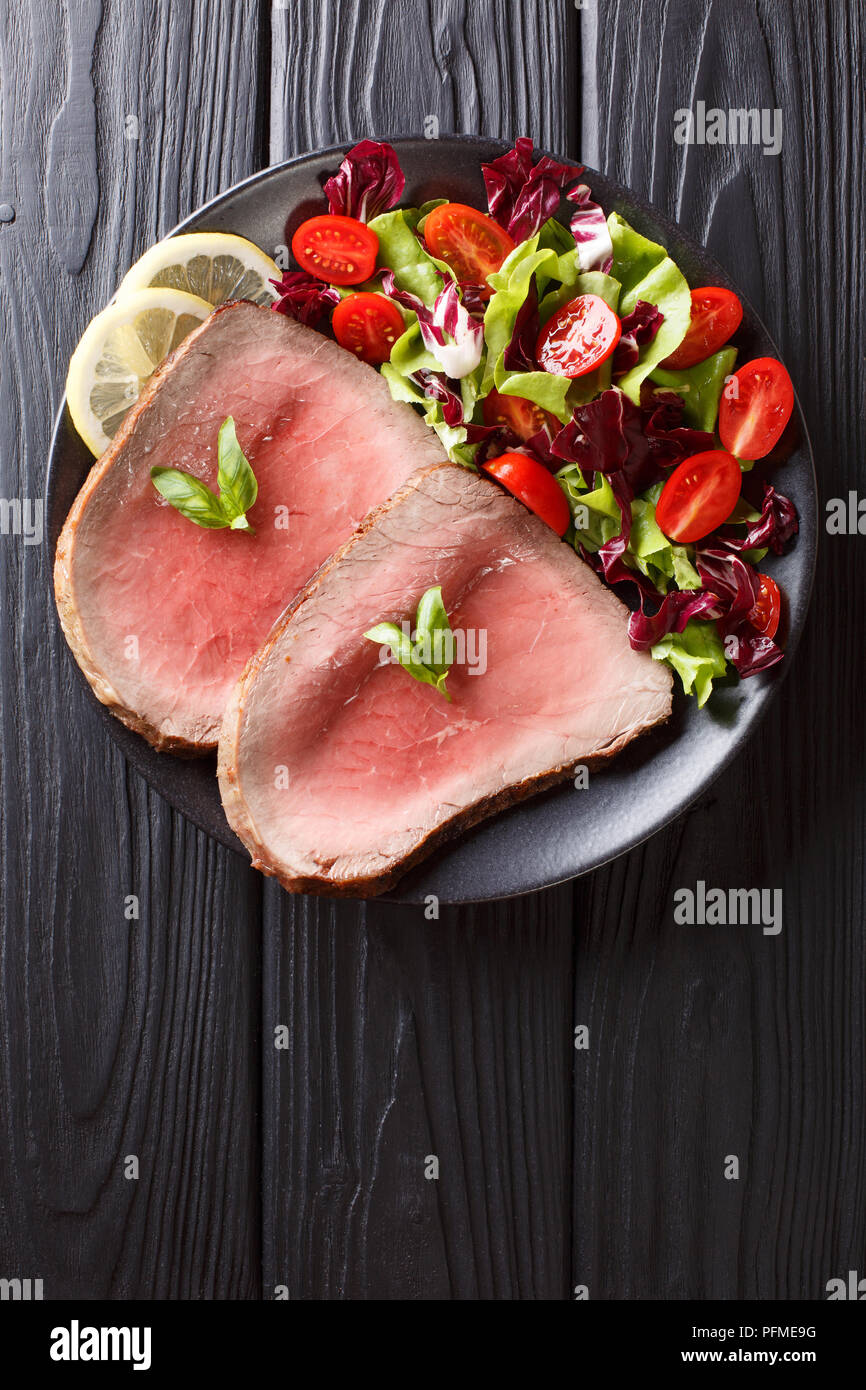 traditional recipe of beef steak is served with a summer vegetable ...
