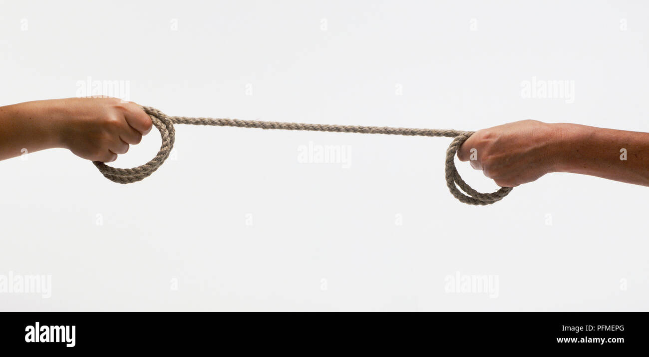 Rope being pulled by two Hands Stock Photo - Alamy