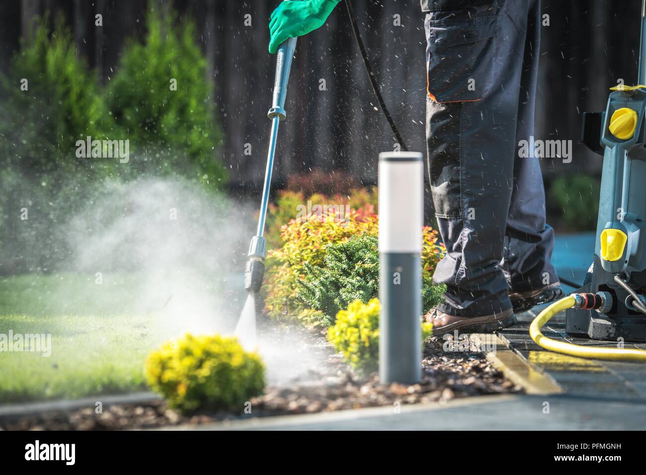 Backyard Garden Paths Cleaning with Pressure Washer Stock Photo - Alamy