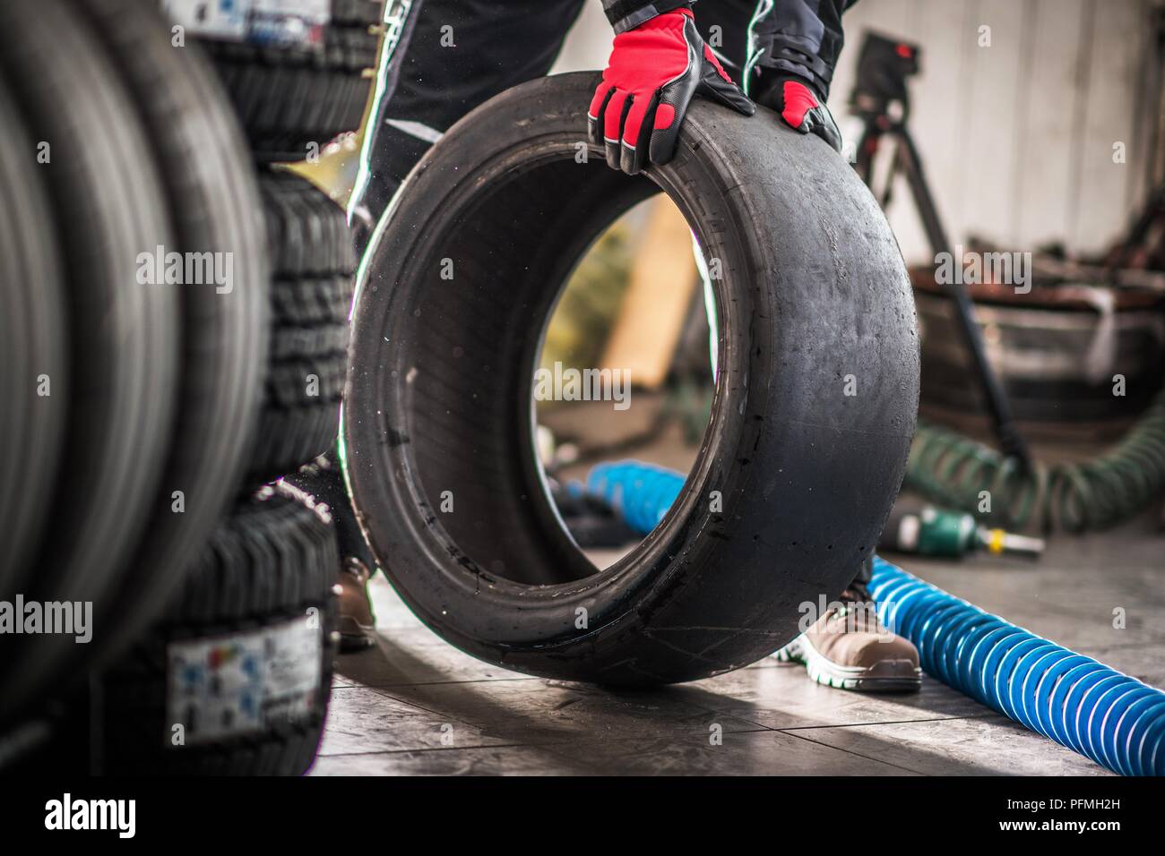 Motorsport Slick Tire. Caucasian Service Worker with Slick Racing Tire ...