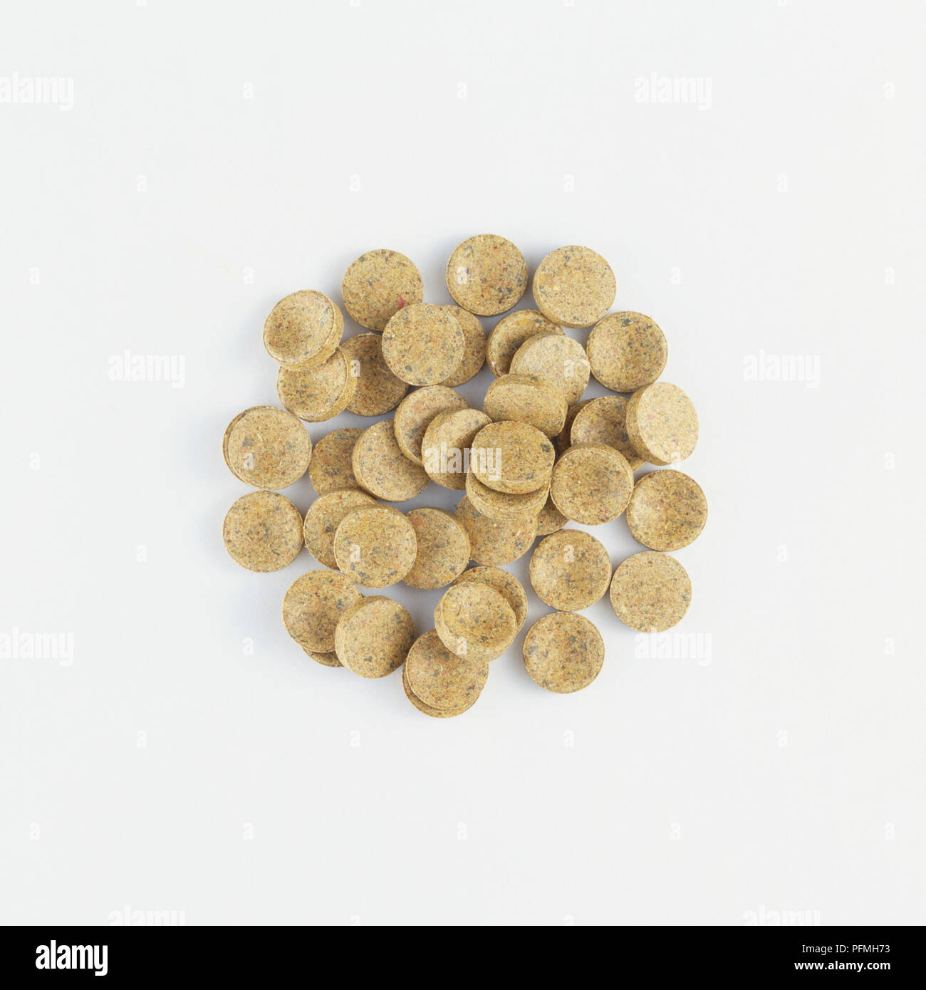 Round tablets of dried, aquarium fish food Stock Photo - Alamy