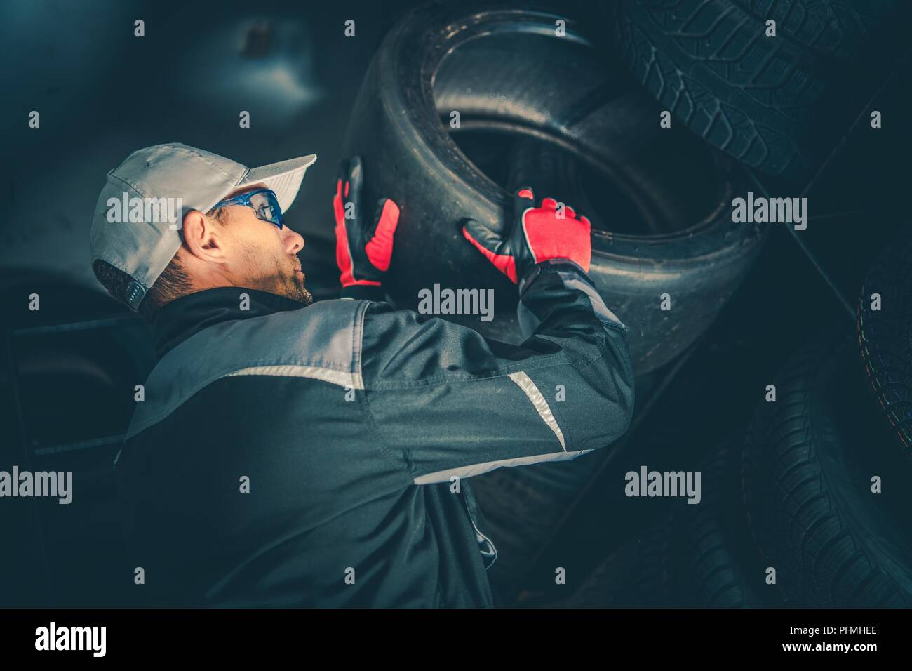 Wheels and Tires Store Worker Taking Off Slick Tire From the Rack Stock ...