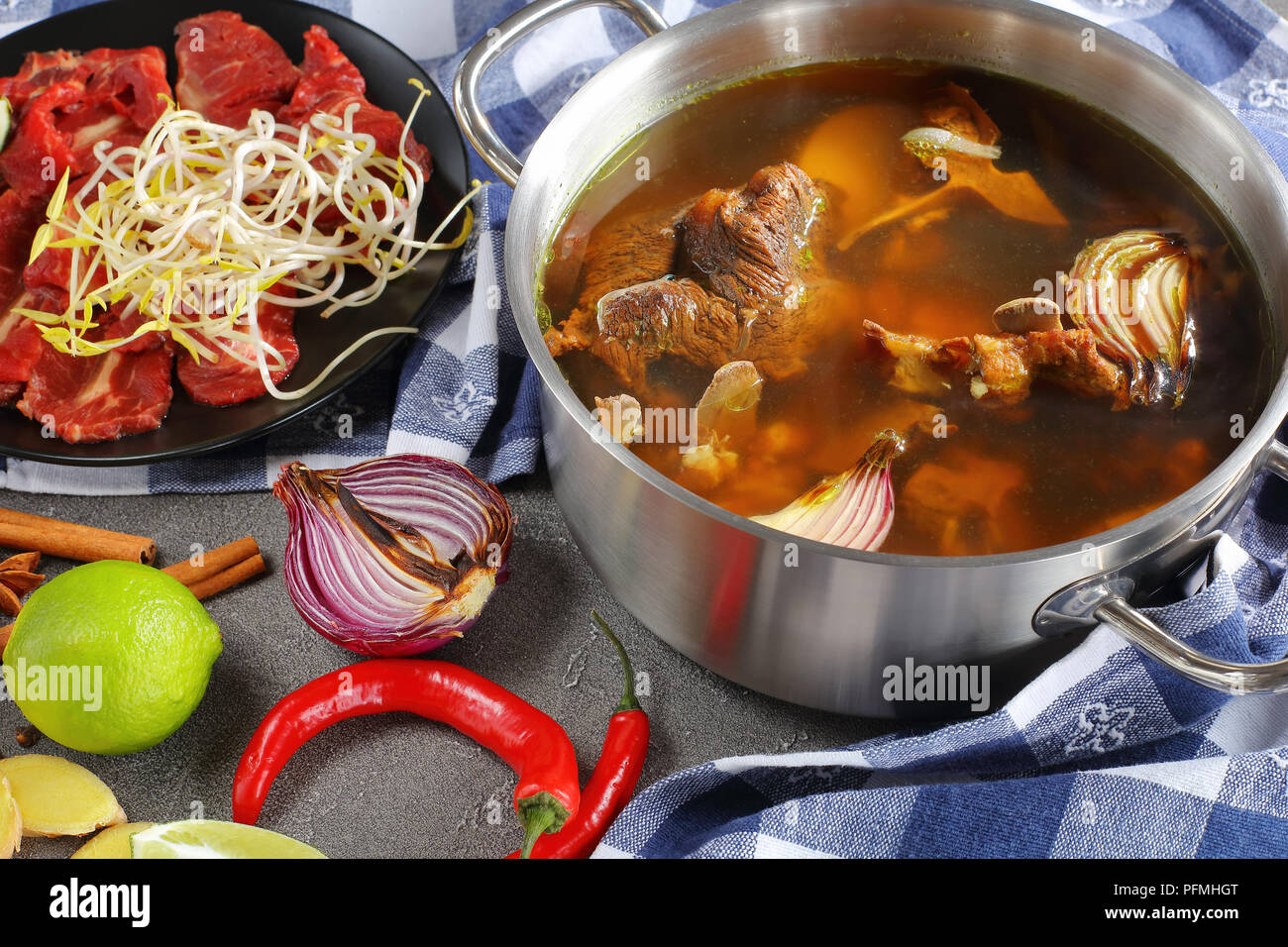 hot beef bone broth and other ingredients for traditional Vietnamese ...