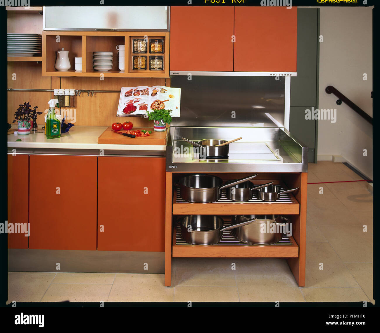 Fitted low-level hob with stainless steel sides, pan storage and pull ...