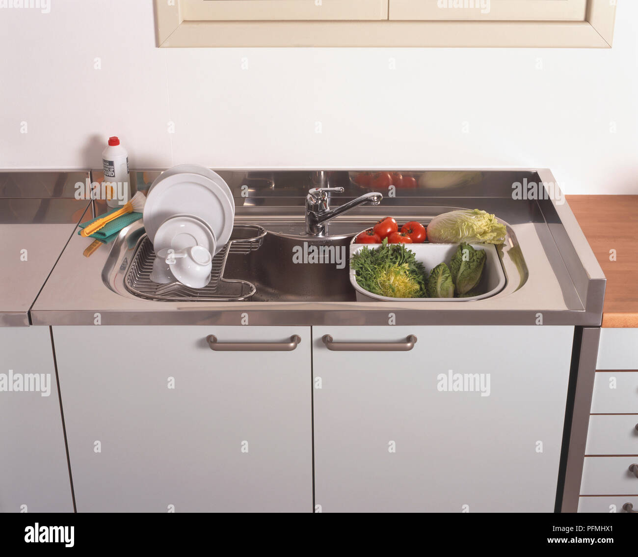 Simple multi-purpose kitchen sink with waste disposal, draining rack ...