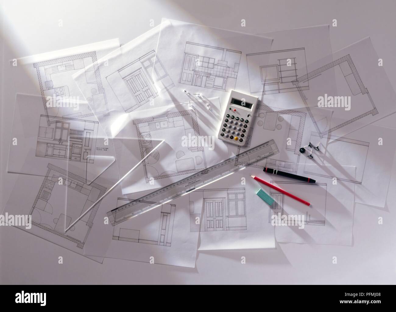 Calculator, ruler, pencil, pen, and rubber on top of architecture ...