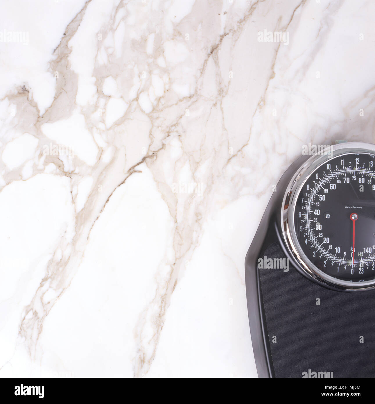 Bathroom scales on white marble floor, close-up Stock Photo - Alamy