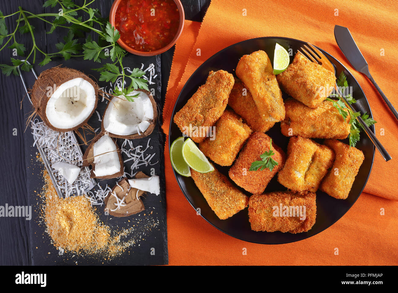 close-up of delicious pieces of crispy fried fish coated with coconut ...