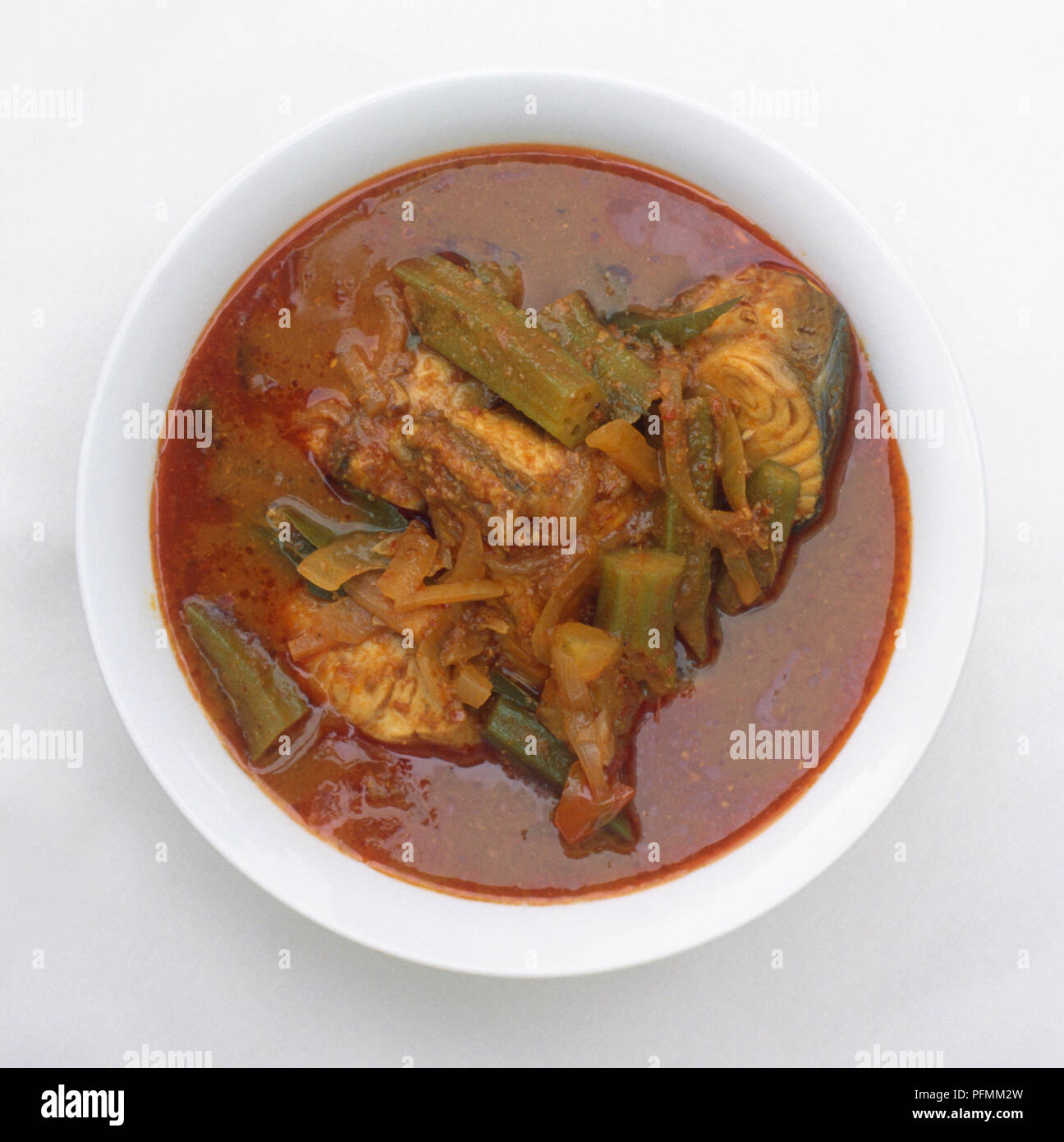 Bowl of Assam Pedas, a Malay dish of fish, brinjal and okra in tamarind ...