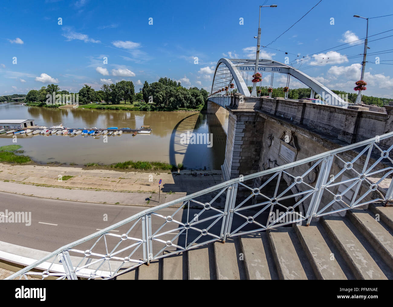 The embankment of Tisza river and the famous Downtown Bridge also known ...