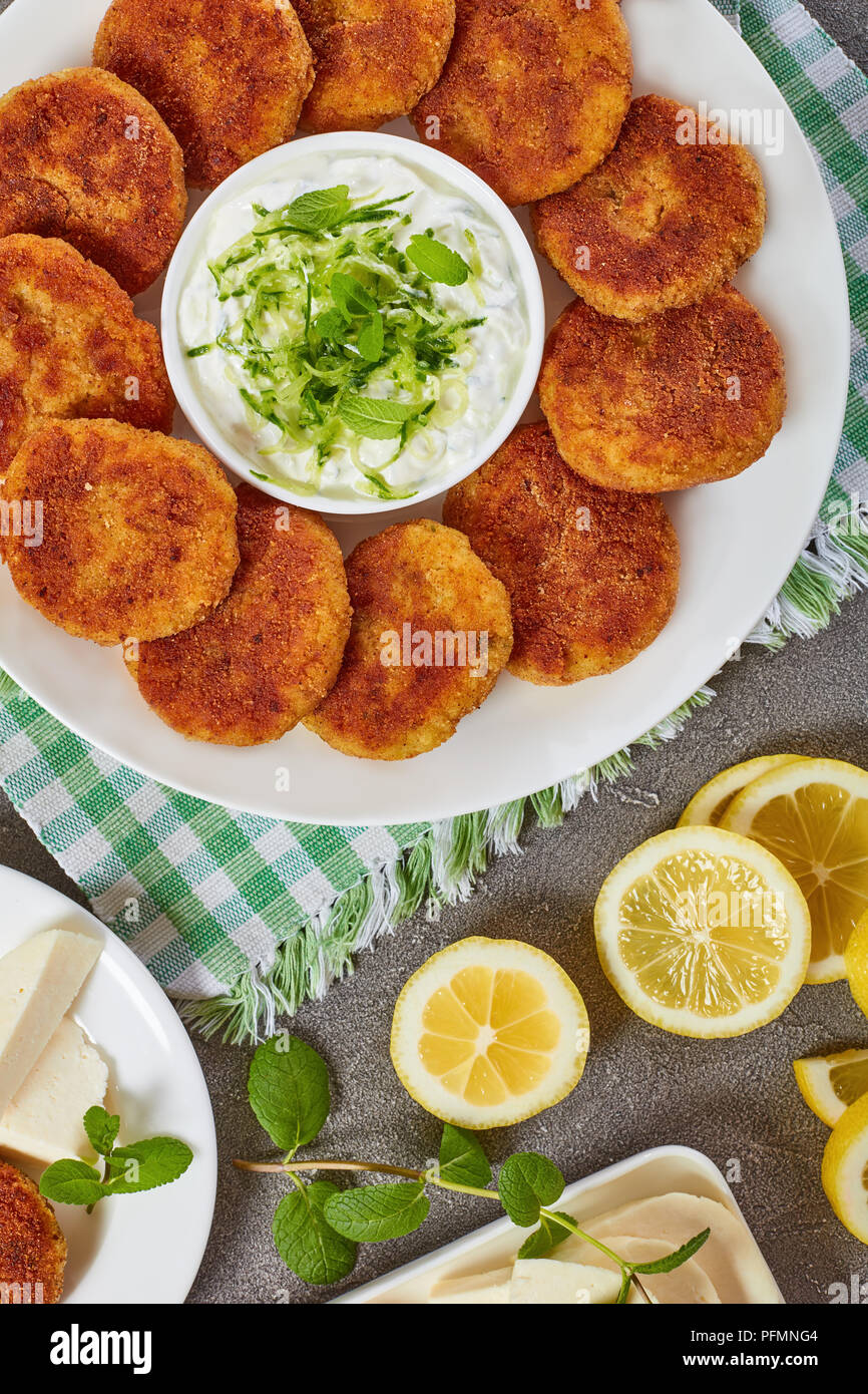 delicious crispy rice cutlets with finely chopped greens on a white ...