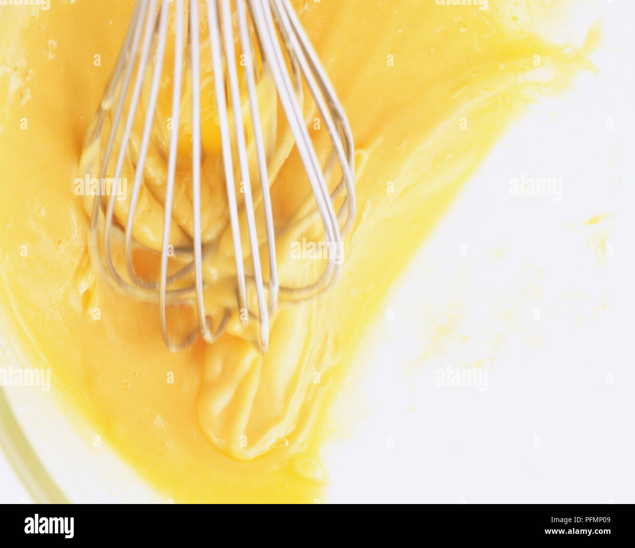 Whisking using a metal, hand-held whisk Stock Photo - Alamy