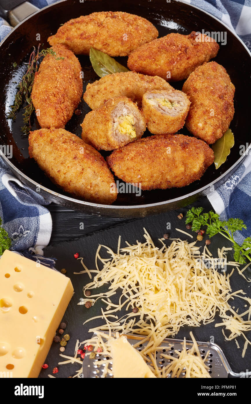 fried juicy breaded meat croquettes with melted cheese filling on a ...