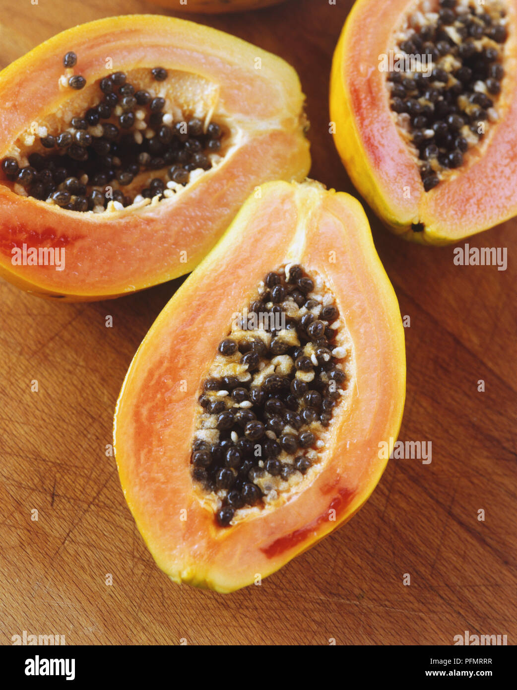 Halved papaya showing the fresh fruit and seeds inside Stock Photo - Alamy