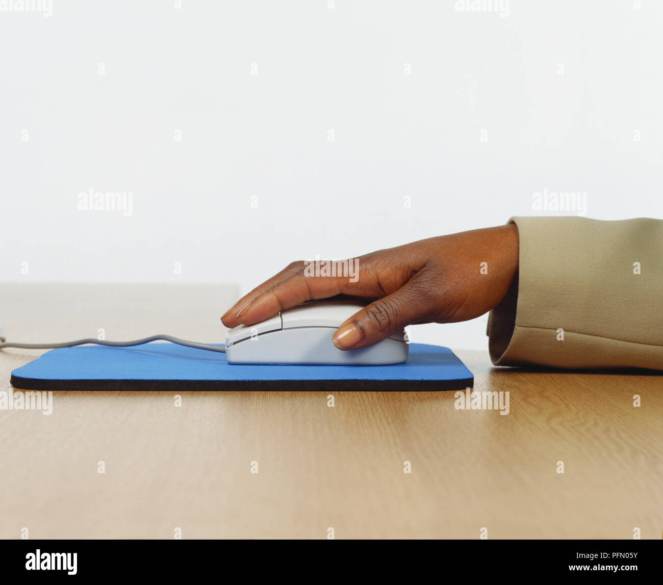 Woman's hand laid over computer mouse, side view Stock Photo - Alamy