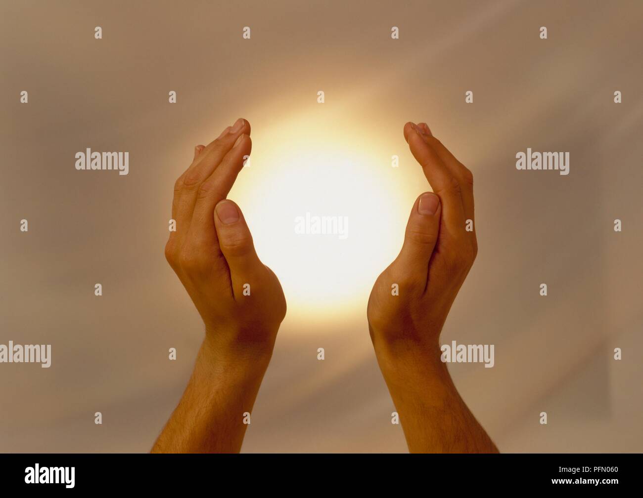 Two hands holding ball of light Stock Photo - Alamy