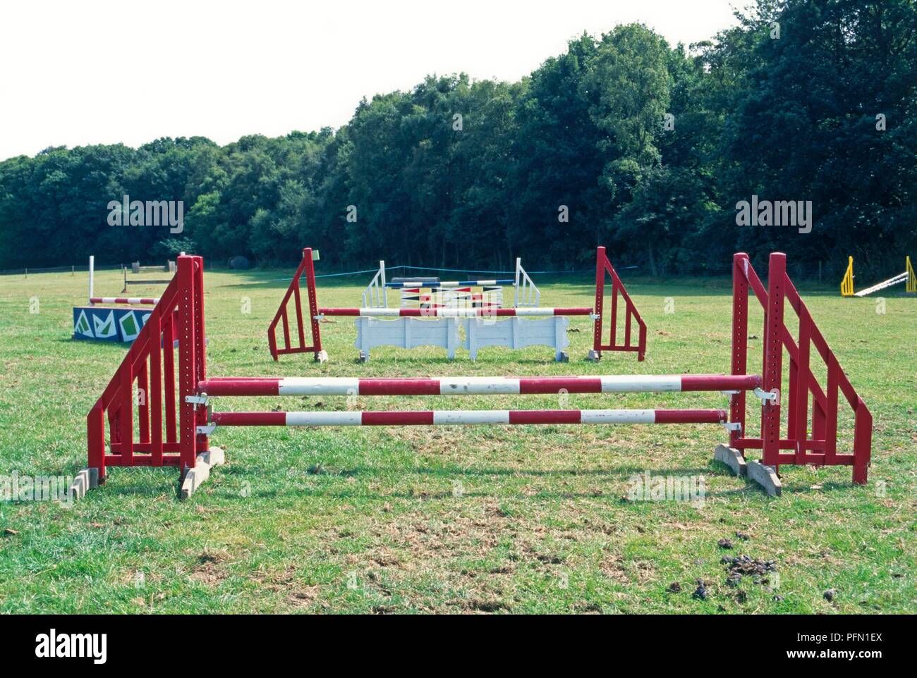 Double show jumping fences set at a distance in field Stock Photo - Alamy
