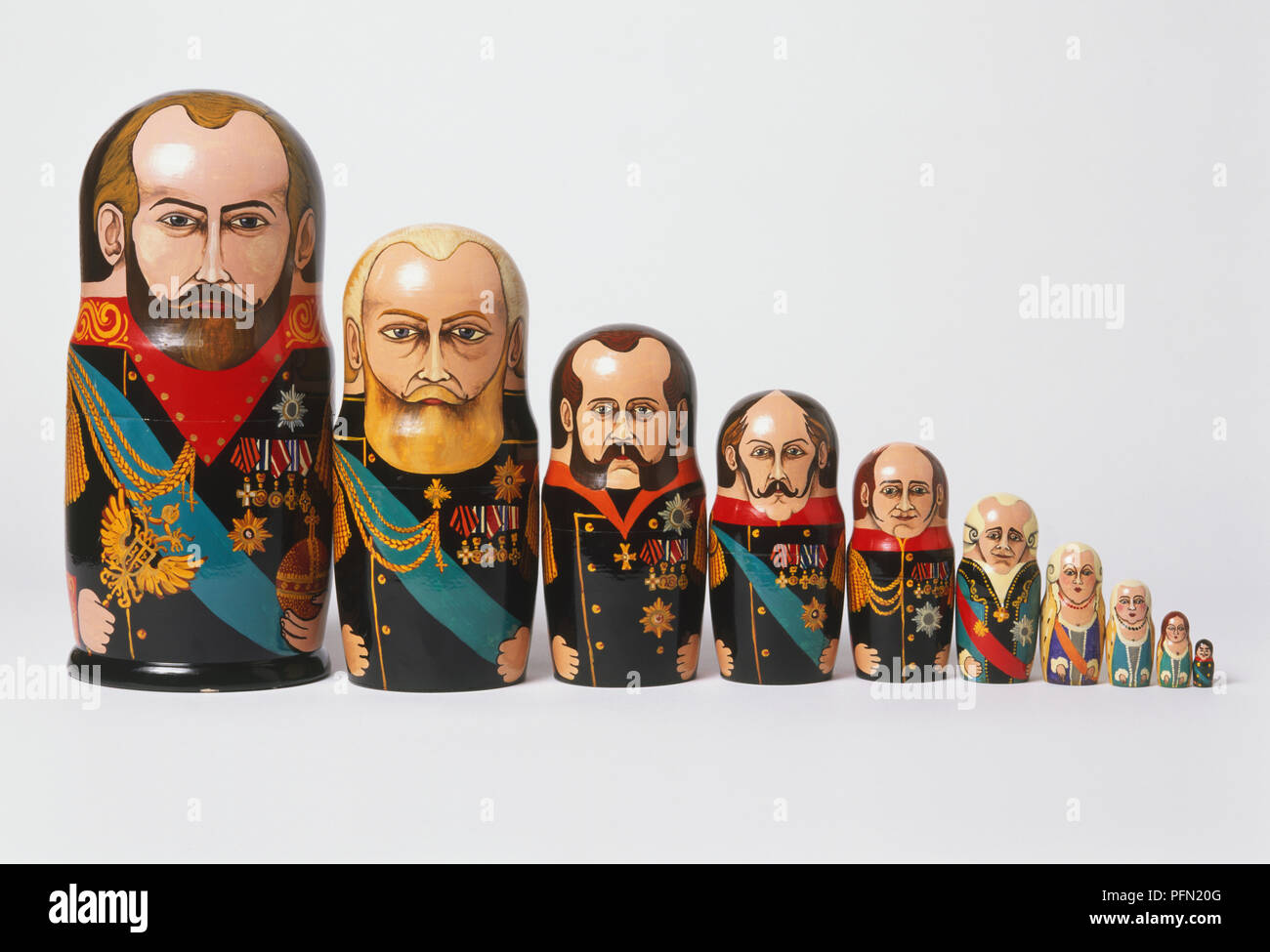 Row of Matryoshka-style dolls of gradually decreasing size, with ...