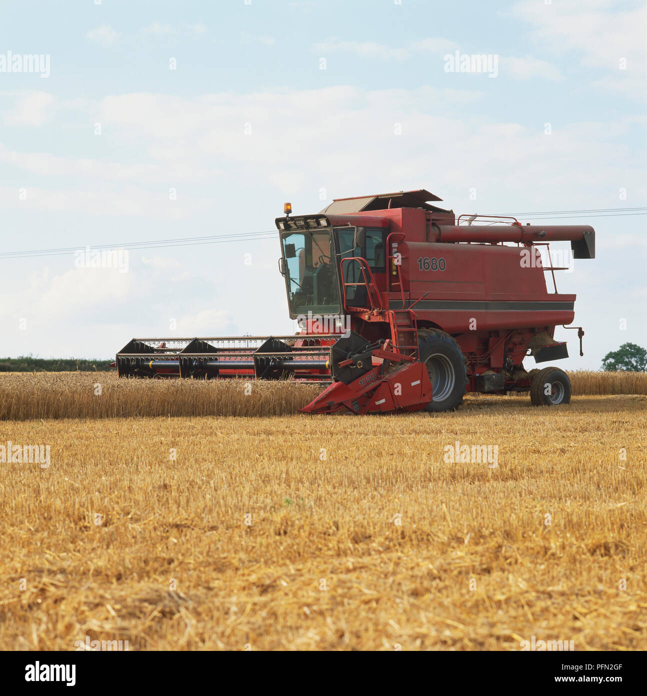 Red combine harvester cutting crops Stock Photo - Alamy