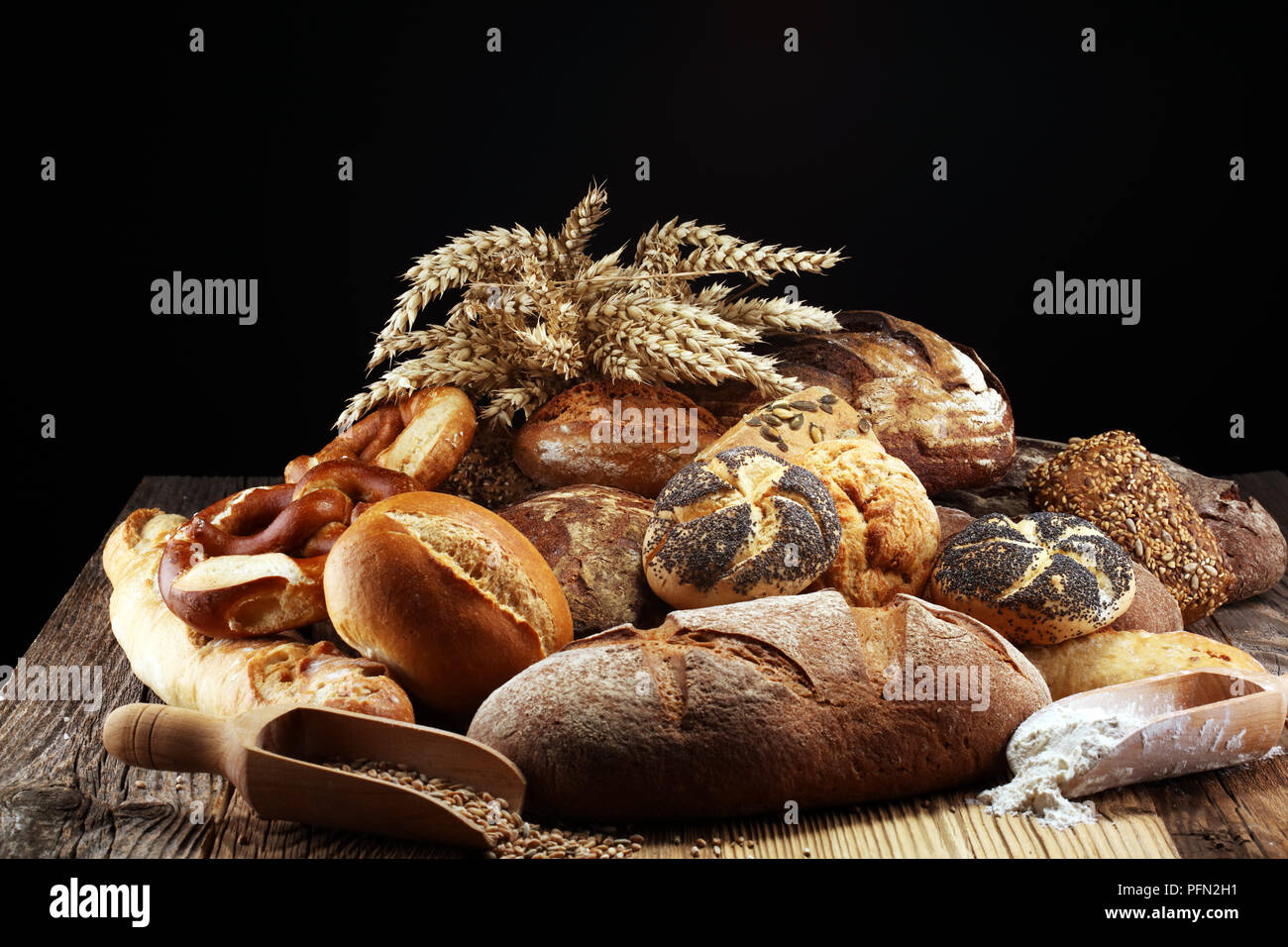 Different kinds of bread and bread rolls on board from above. Kitchen ...