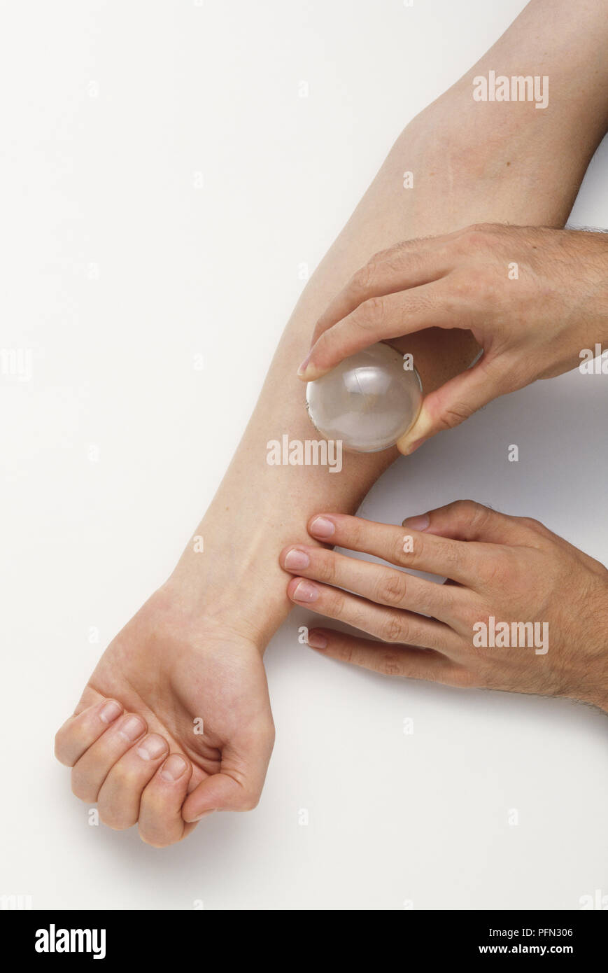 Rolling a ball along inside of someone's forearm (moxibustion Stock ...