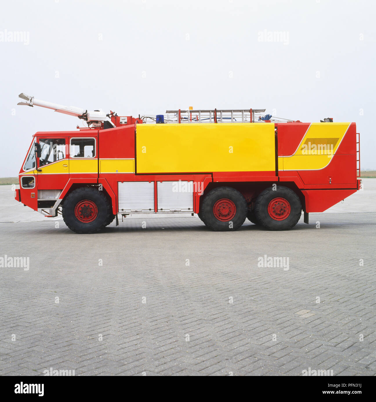 Red and yellow fire engine, side view Stock Photo - Alamy