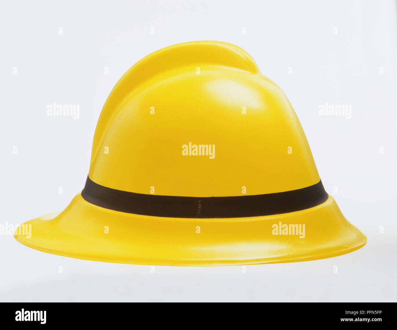 Yellow helmet with black stripe, side view Stock Photo - Alamy